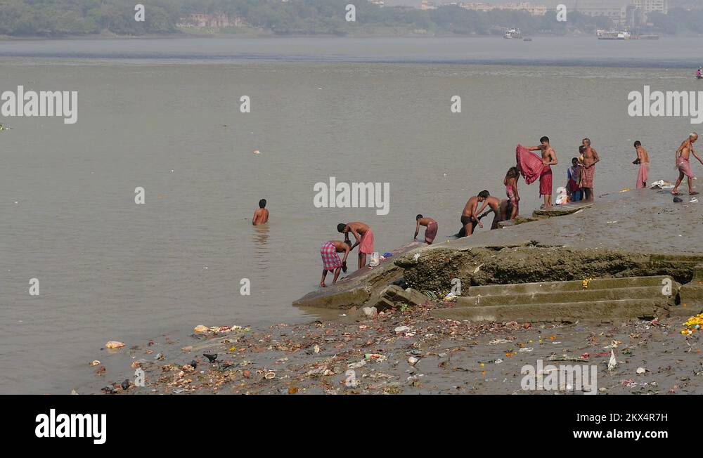 People washing clothes, praying and doing their ablutions on the ...