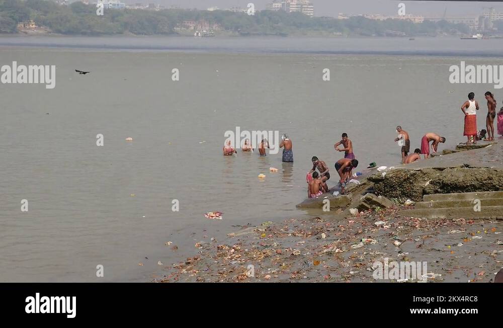 People washing clothes, praying and doing their ablutions on the ...