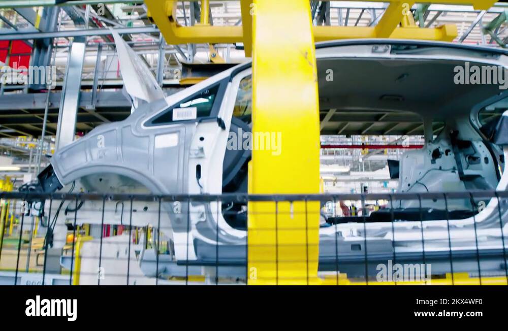 Mass production in car manufacturing industry. Car lifts for assembly ...