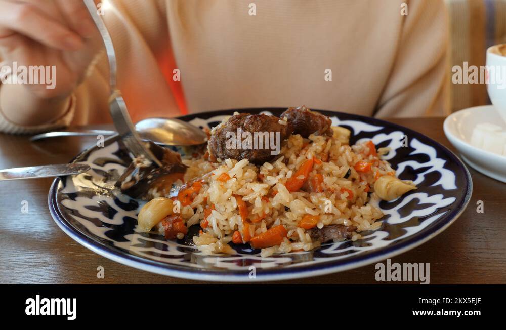 someone eats pilaf in a restaurant of national cuisine. 4k, slow motion ...