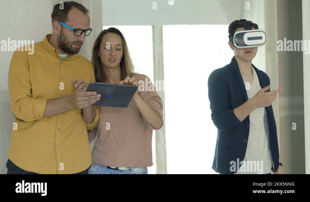 Family with vr goggle and tablet watching virtual project at their new ...