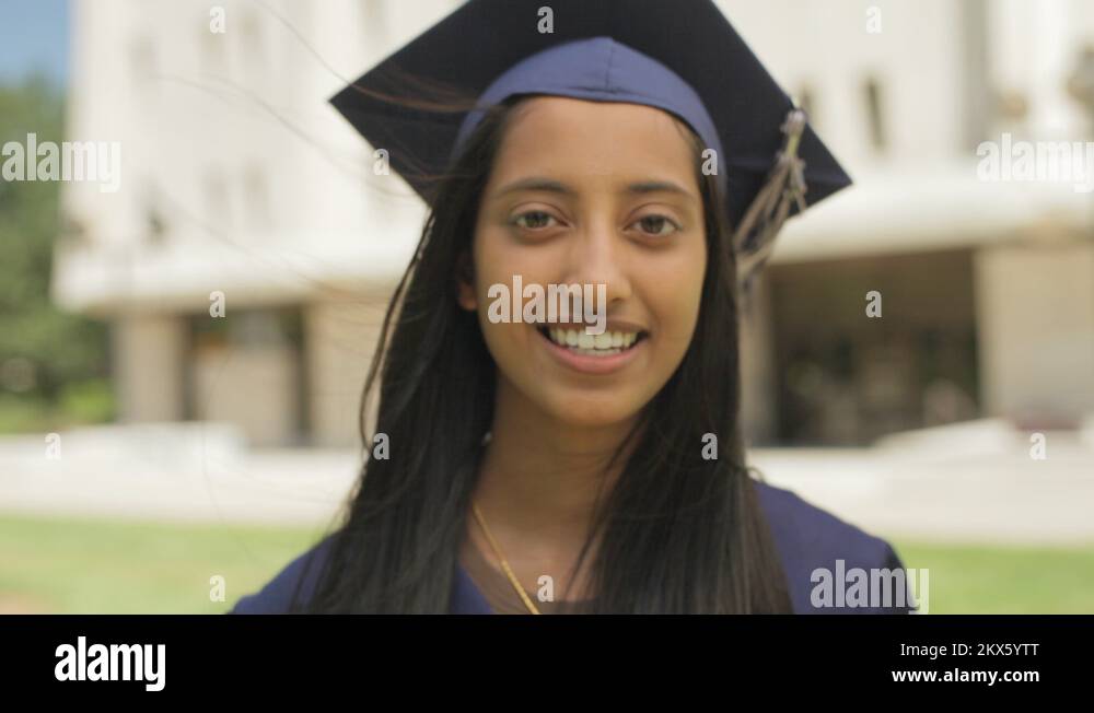 Portrait of a young Indian woman wearing graduation cap and gown Stock ...