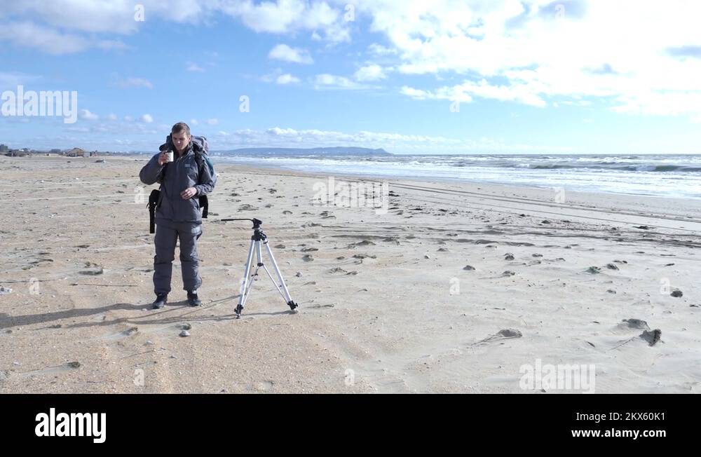 4k, professional photographer, hiker, walks in the desert with a tripod ...