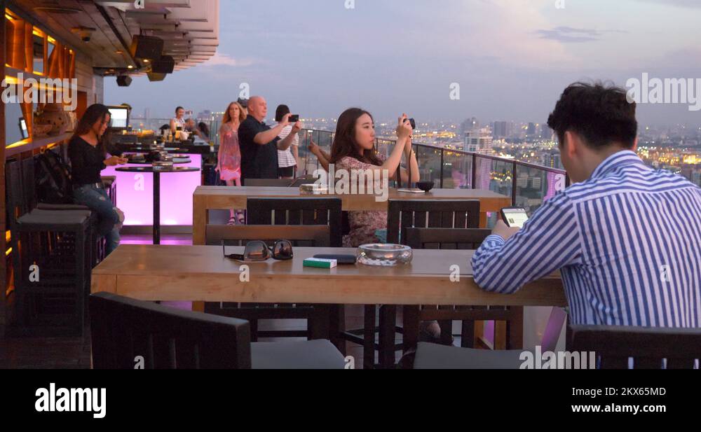people taking photos from Bangkok rooftop bar Stock Video Footage - Alamy