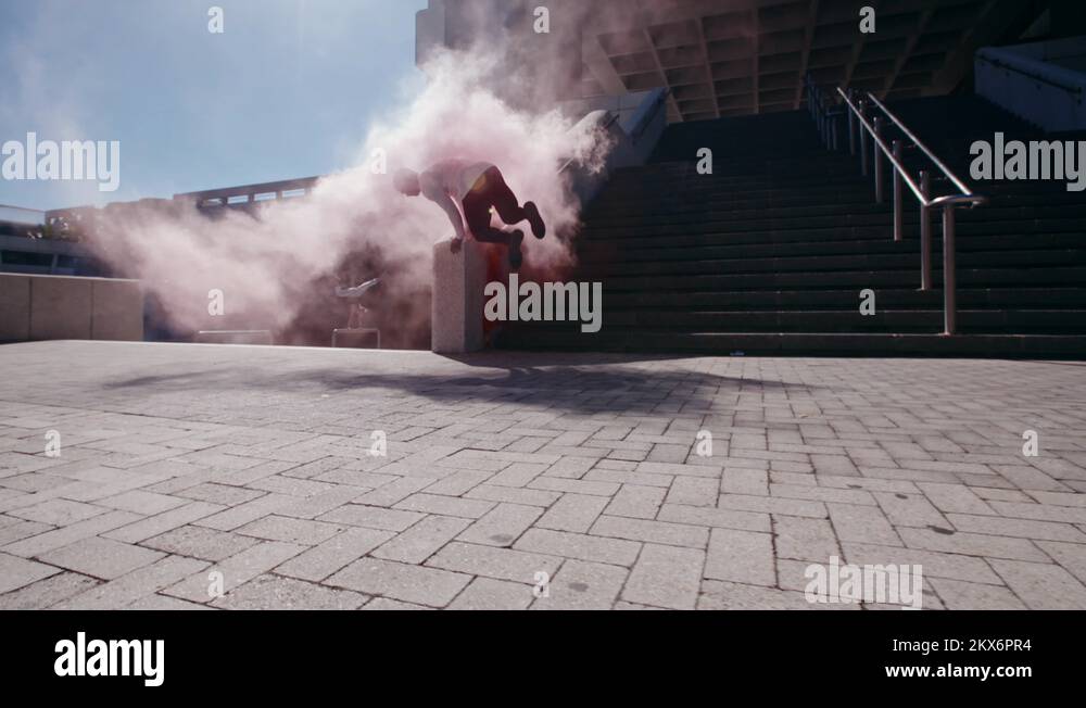 Free runners doing parkour with smoke grenades Stock Video Footage - Alamy