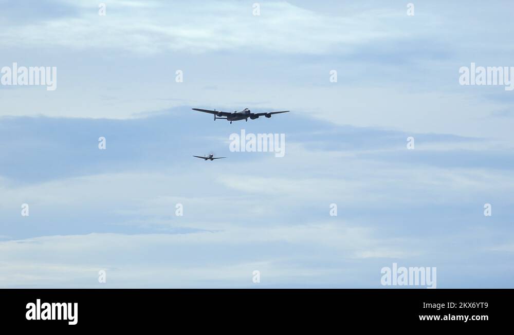 Lancaster bomber with spitfire flying in blue sky with clouds 4K Stock ...