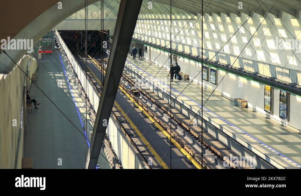 A subway train leaves a station and enters a tunnel - top view - cables ...