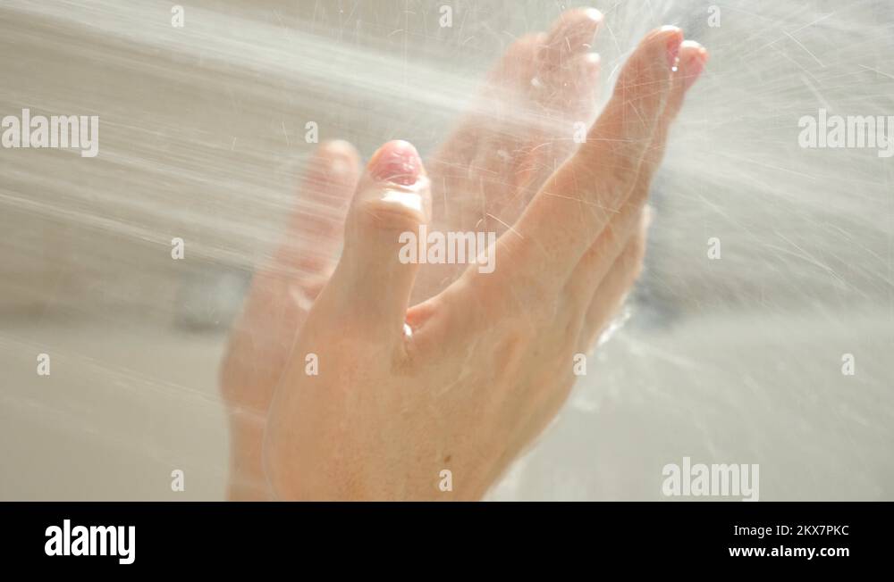 female hands under streams of water from the shower. moistening of ...