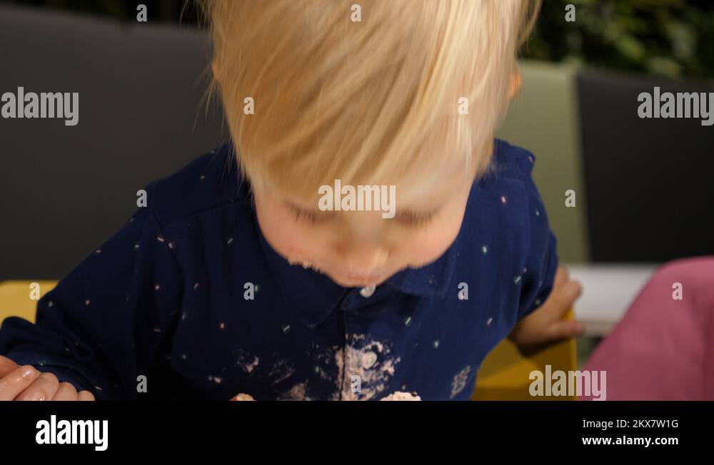 Two years child boy funny eating birthday cake lapping tongue face ...