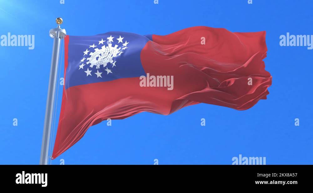 Flag of Myanmar or Union of Burma waving at wind in slow in blue sky ...