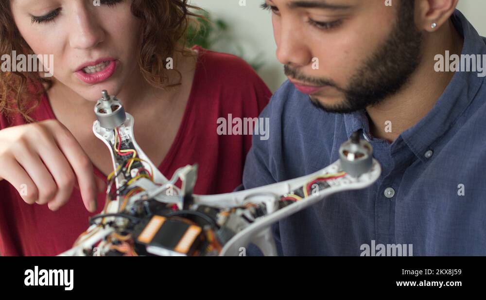 Hip Young and Genuine Man and Woman Computer Scientists Examening The ...