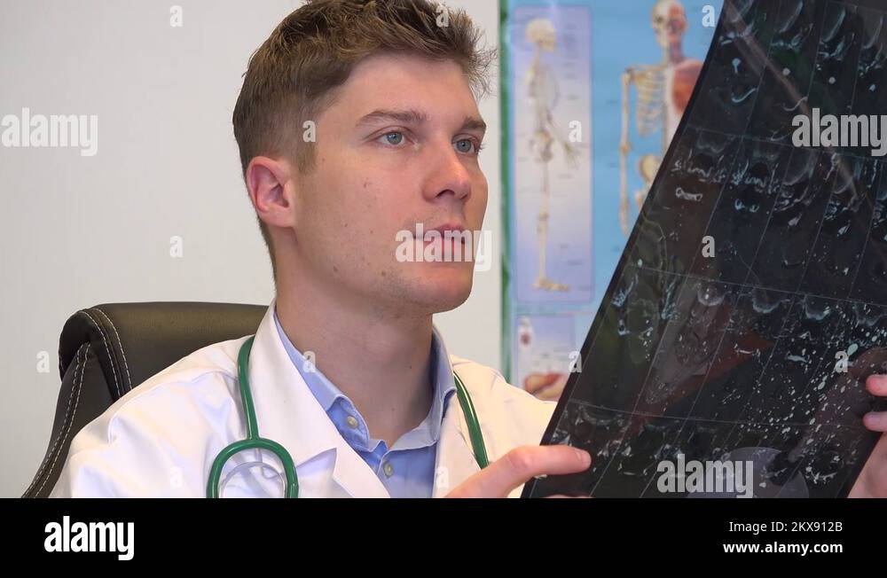 Close up young radiologist physician doctor analyze X ray radiography ...