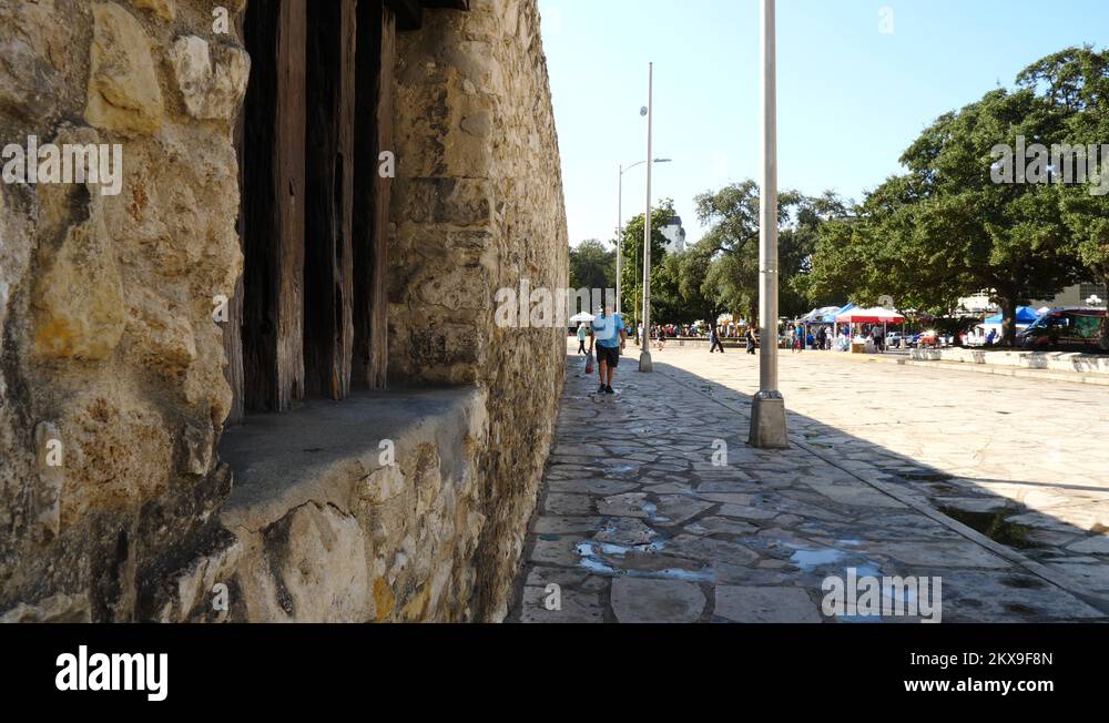 Man Walking By Wall of The Alamo Mission San Antonio Texas Blue Sky ...