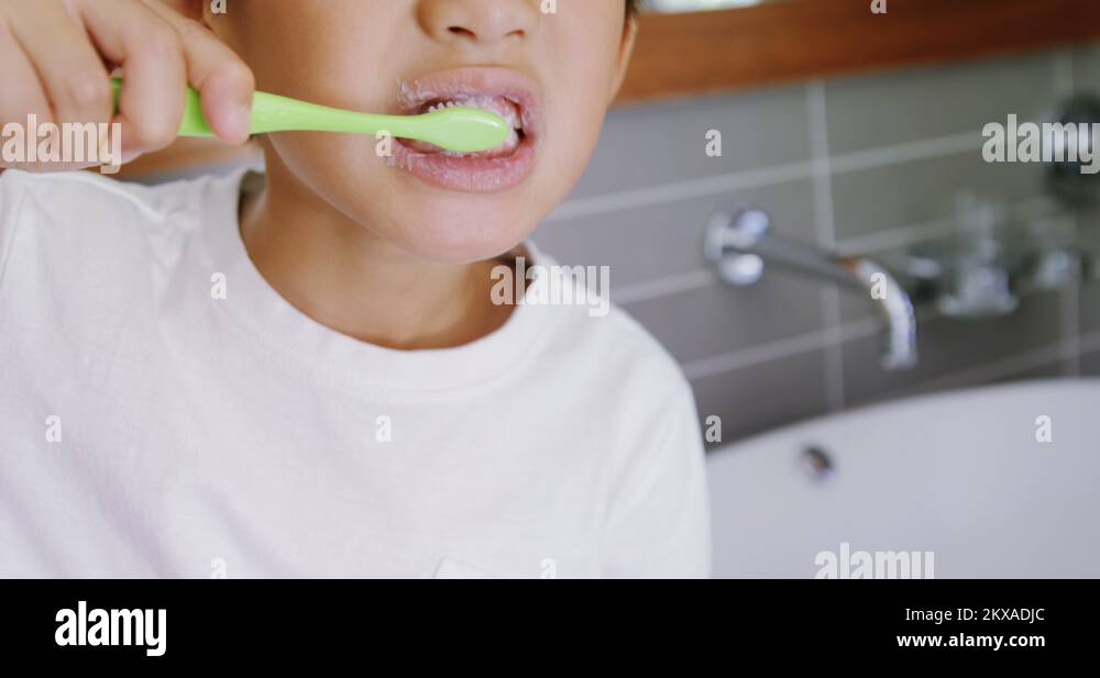 Boy brushing his teeth in bathroom 4k Stock Video Footage - Alamy