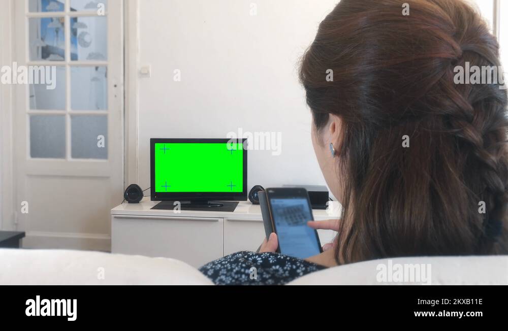 Using smartphone watching tv Stock Videos & Footage - HD and 4K Video ...