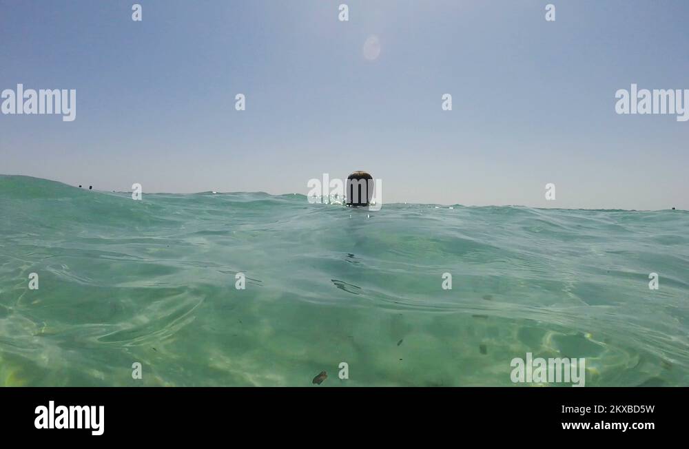 Little girl taking a bath in a beautiful turquoise sea, gopro footage ...