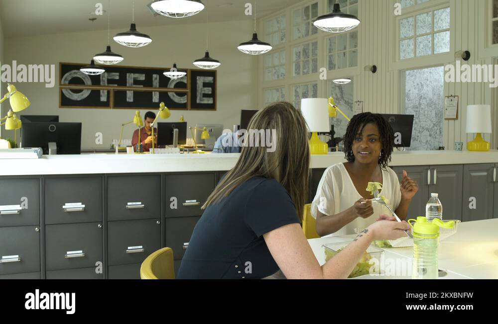 Two young women having lunch in an office Stock Video Footage - Alamy