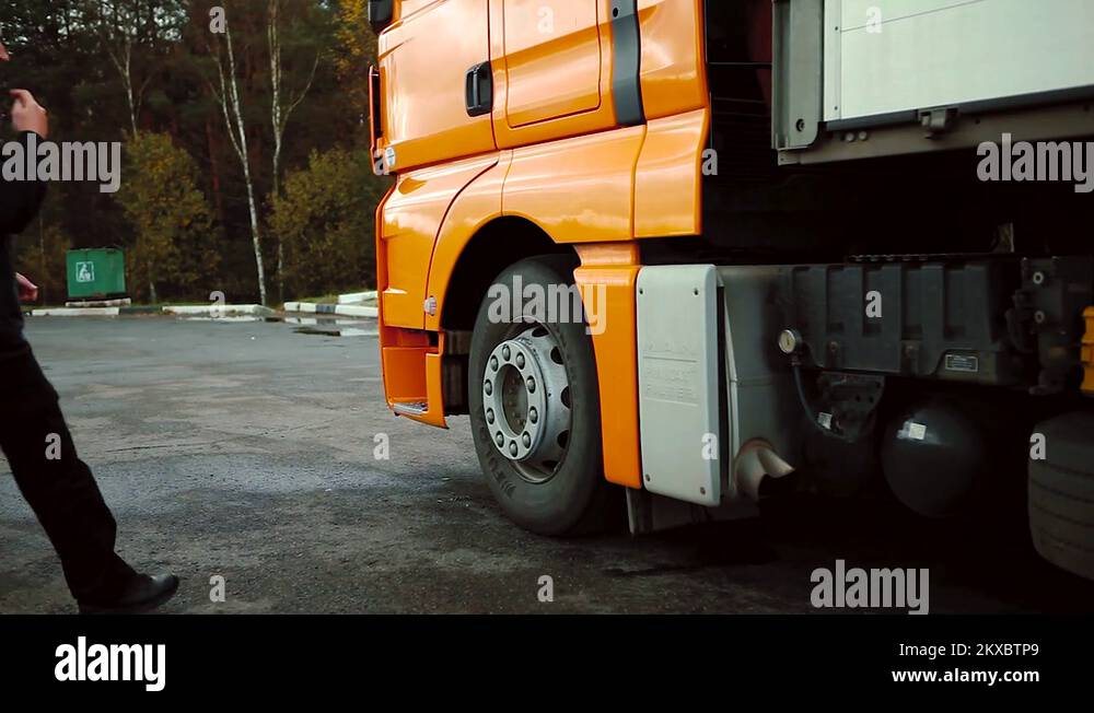 Driver starts motion of the cargo TIR transportation truck from parking ...