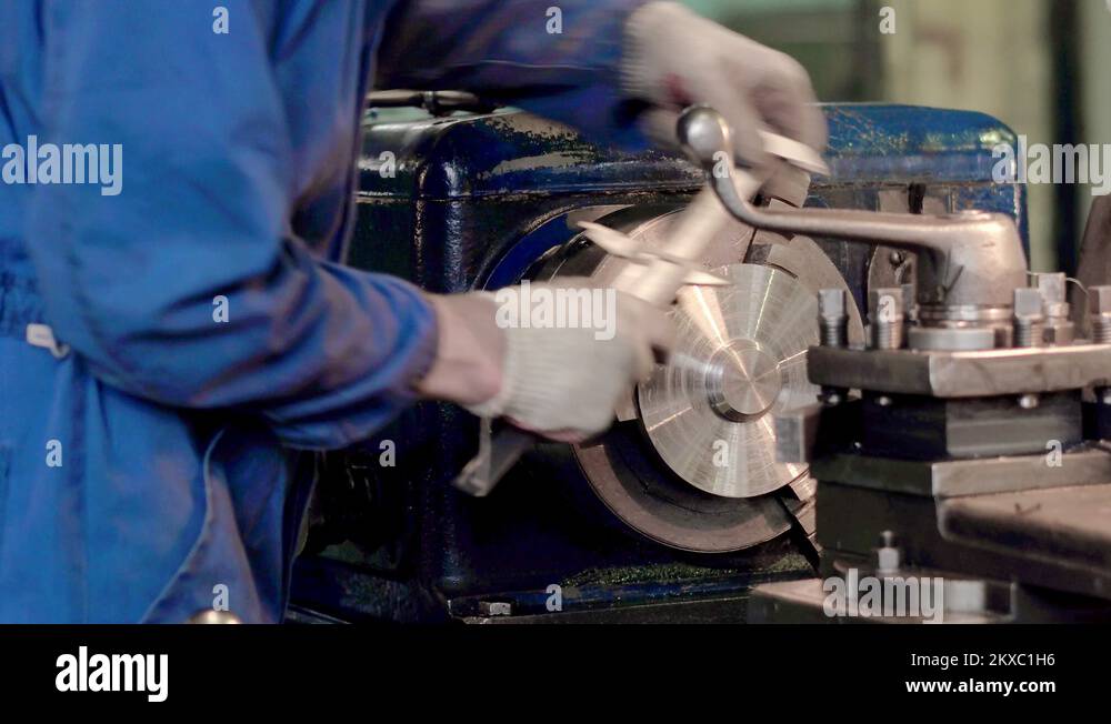 Employee using caliper for measuring detail during working on turning ...