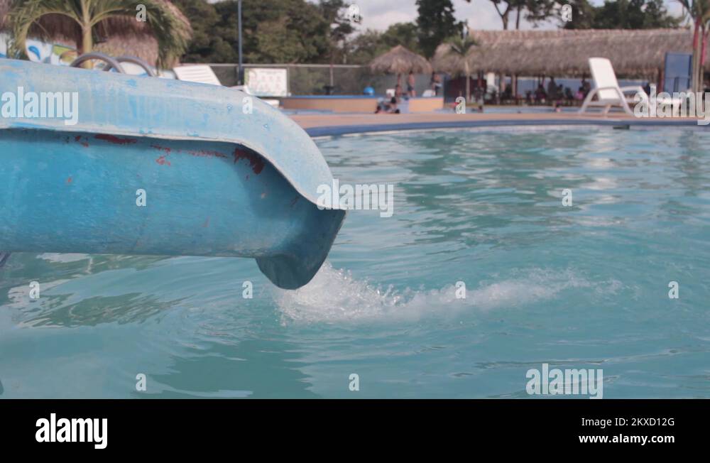Colorful plastic water slide in pool at water park during day time ...