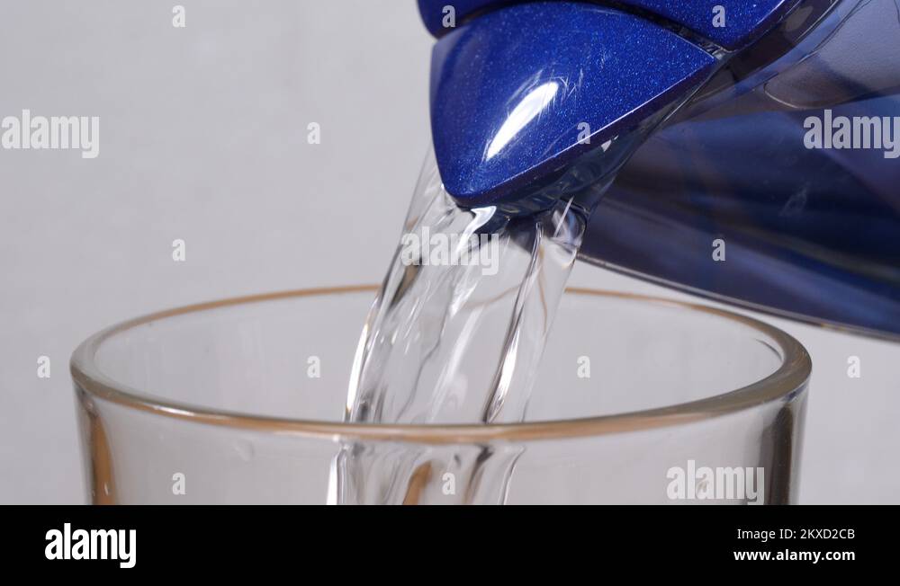 Pouring clean water from filter container into glass Stock Video ...