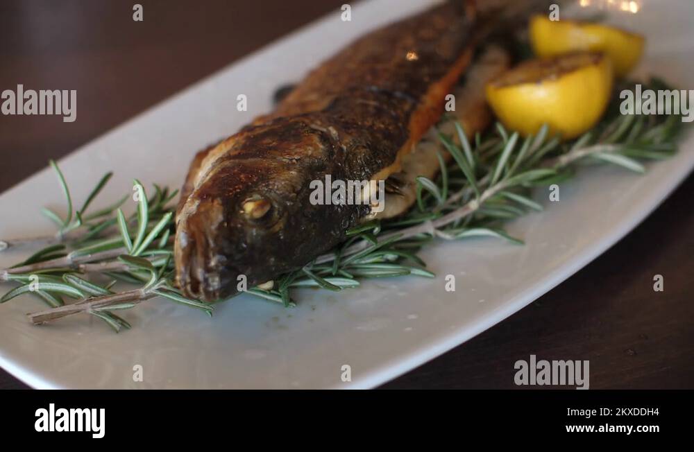 Food Chef cooking Fried fish fillet covered in batter herbs spices ...