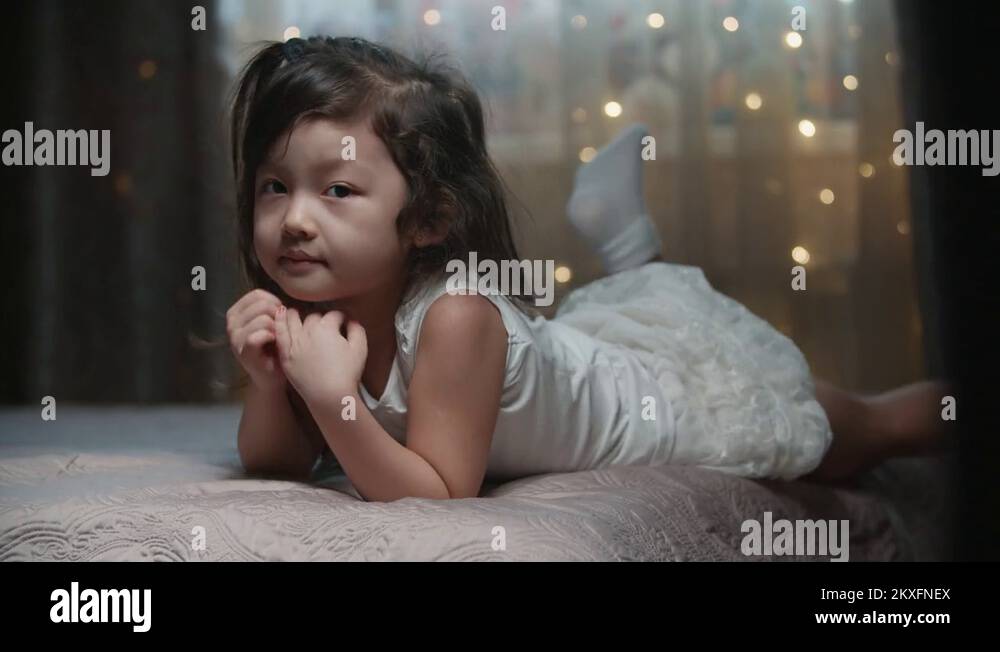 little 5-6 years old cute asian girl having fun, smiling and dreaming in her Stock Video Footage ...