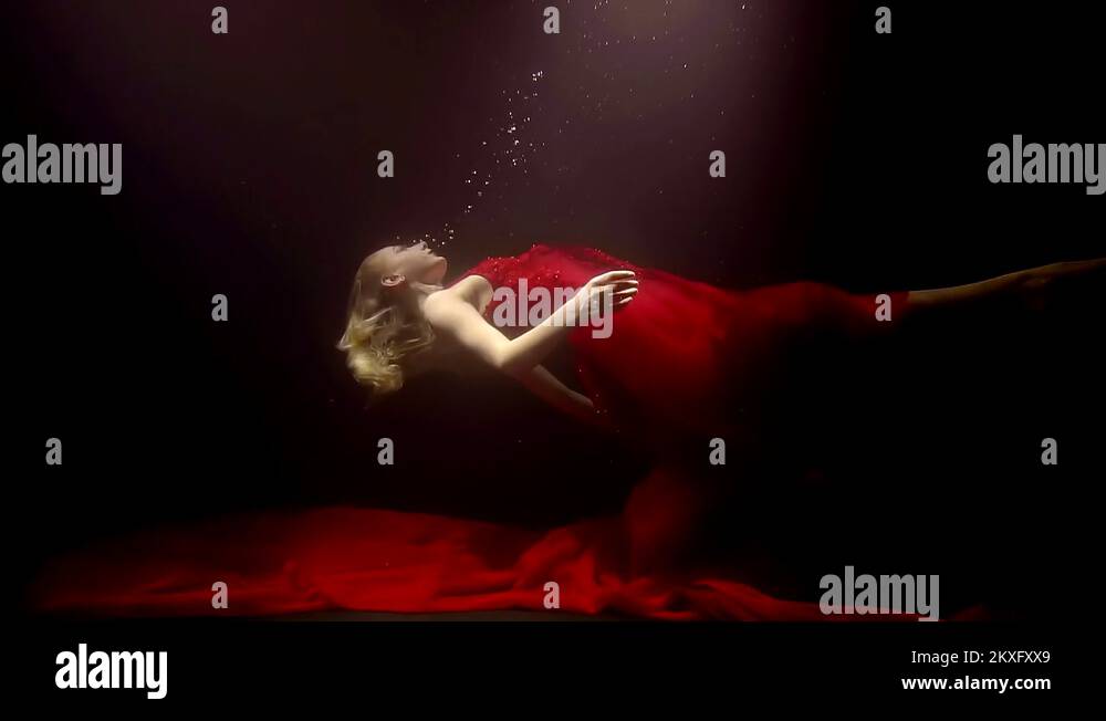 Beautiful body of lovely blonde girl is floating up from the bottom of ...