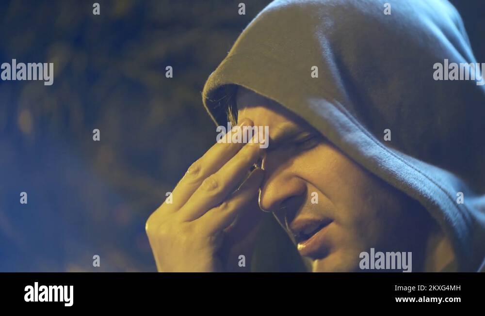 Profile of a sad man with a hood. close-up, background blur, bokeh. 4k ...