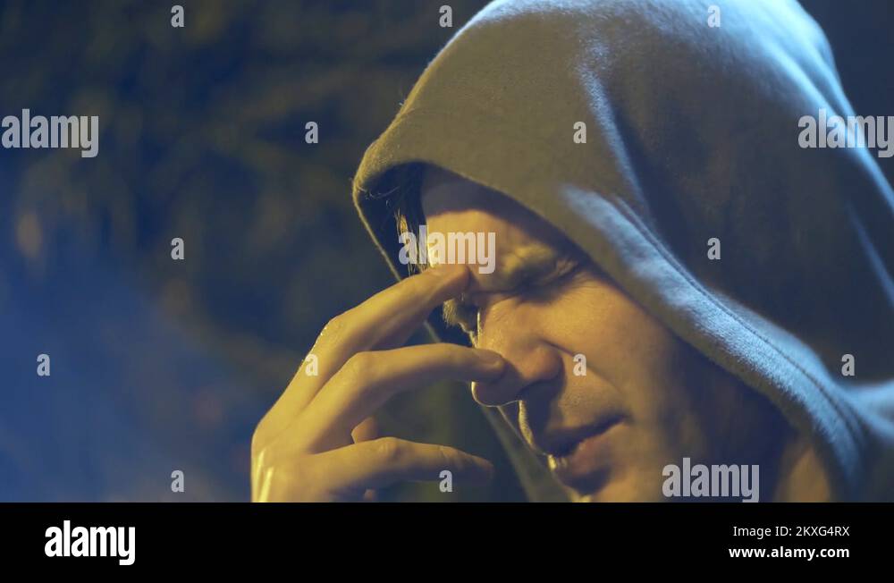 Profile of a sad man with a hood. close-up, background blur, bokeh. 4k ...
