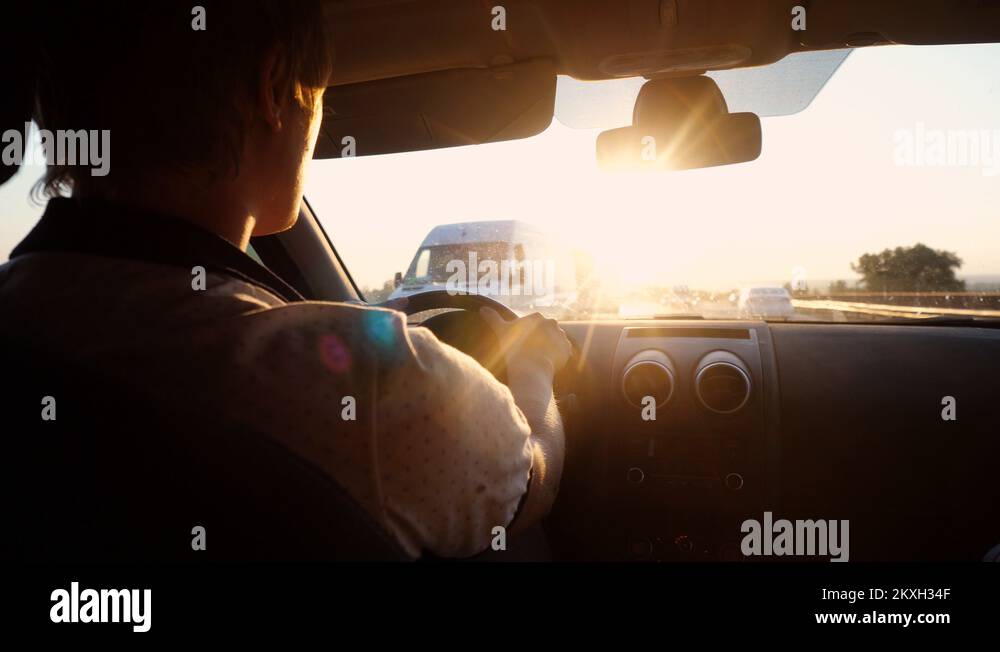 Man Driving a Car at Sunset. Beautiful Road with amazing lens flare ...