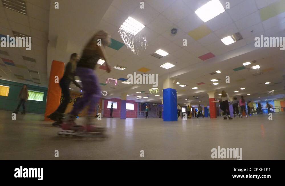 Many people of children and adults go roller-skating on the inside ...