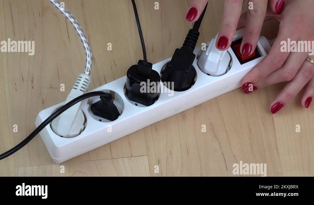 woman and man hands turn off electricity extension switch and unplug ...