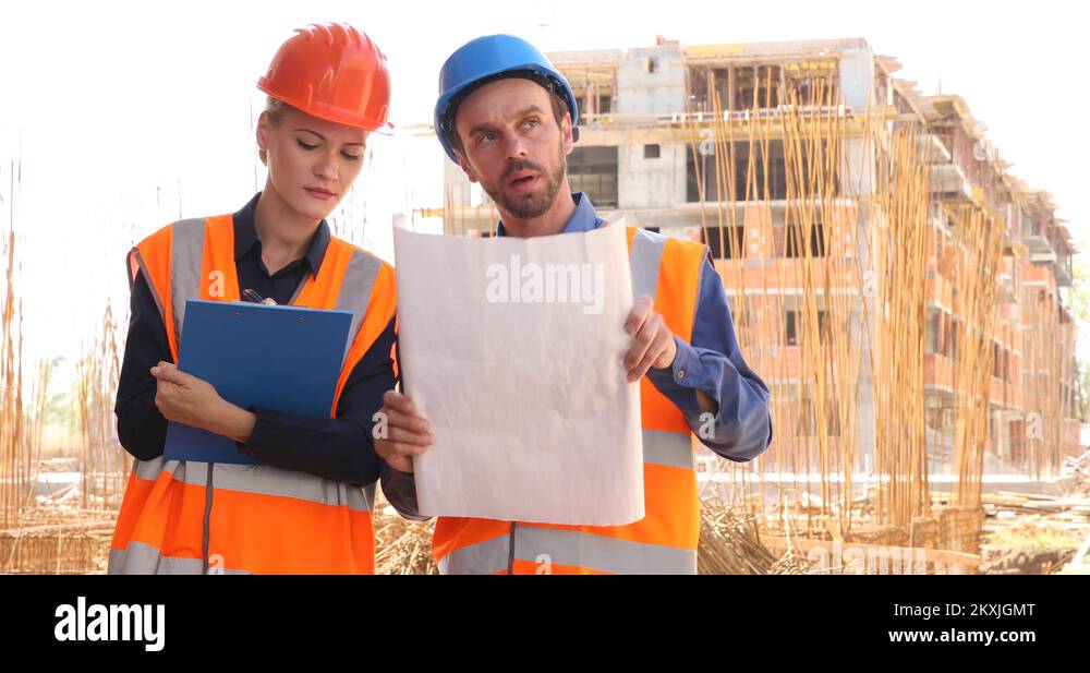Team of Engineer Workers Examining Architecture Blueprint Plan ...