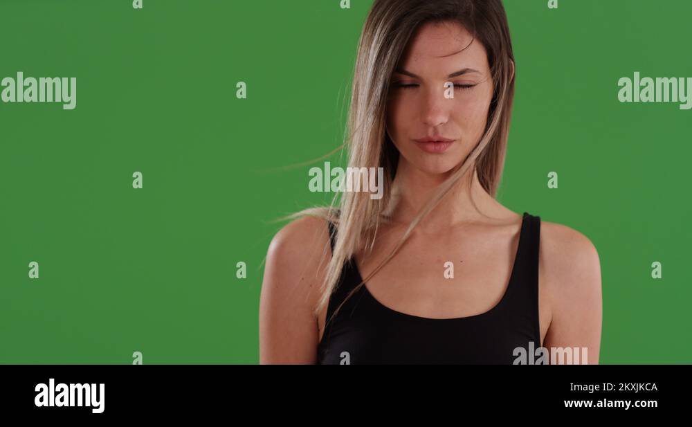 Fit young millennial woman flexing biceps and kissing her muscles on ...