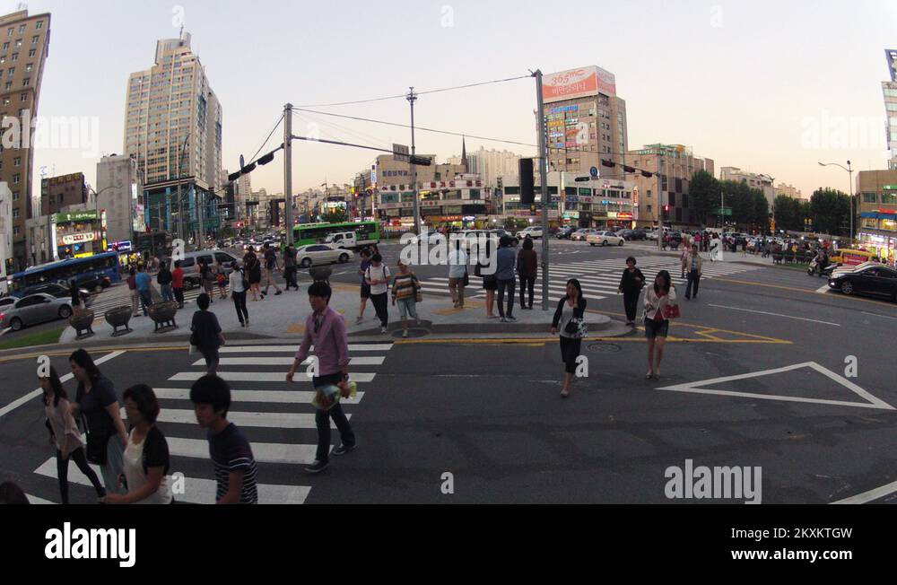 Busy Asian Street Intersection with People crossing the road and heavy ...