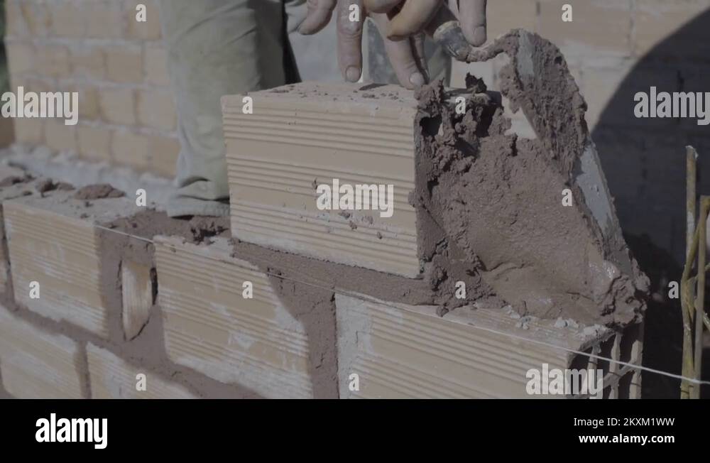 Construction bricklayer worker building walls Stock Video Footage - Alamy