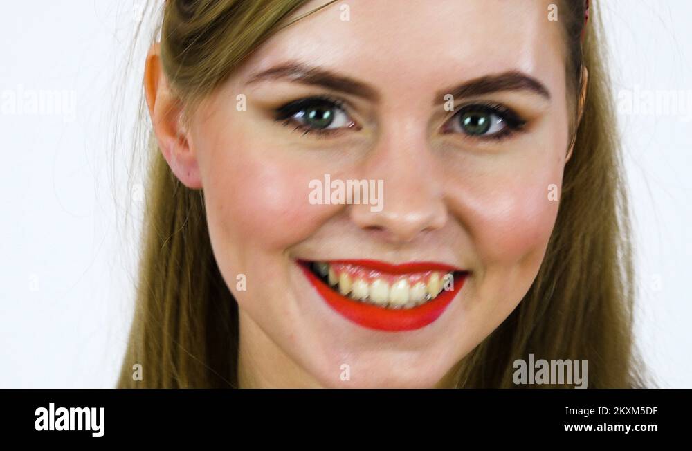 A beautiful 50s pin-up girl smiles at the camera - face closeup - white ...