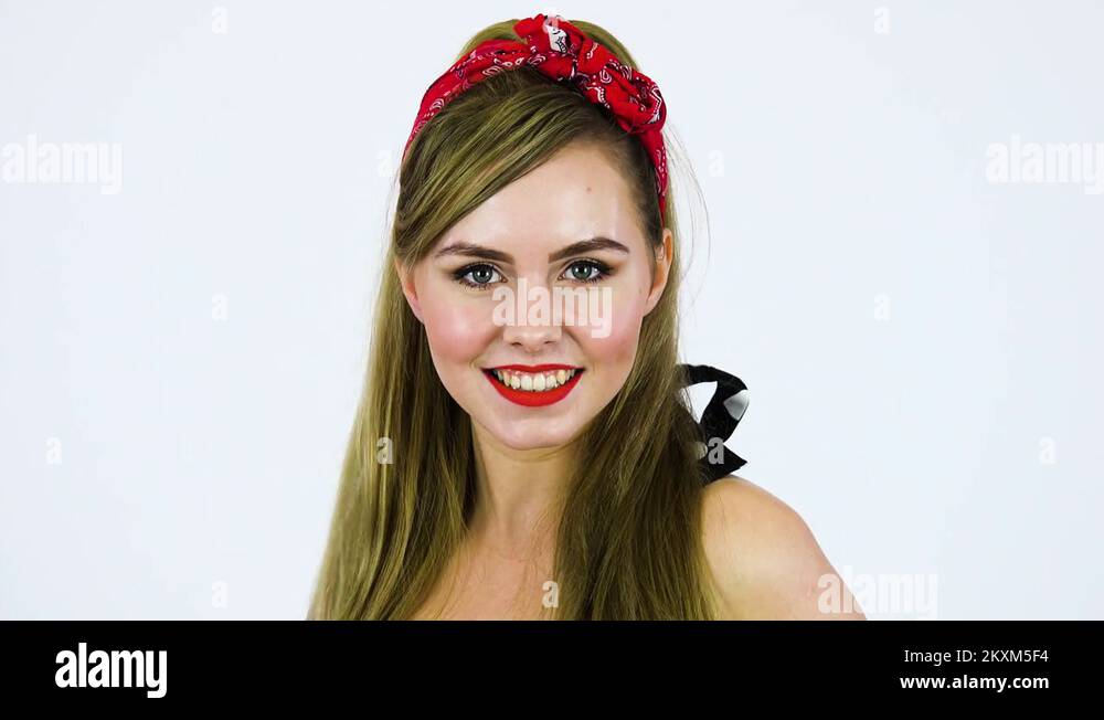 A beautiful 50s pin-up girl smiles at the camera - face closeup - white ...