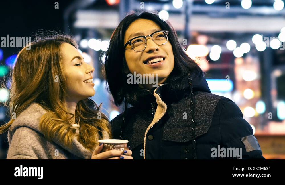 Happy girl hugging her boyfriend and kissing him in street Stock Video Footage - Alamy