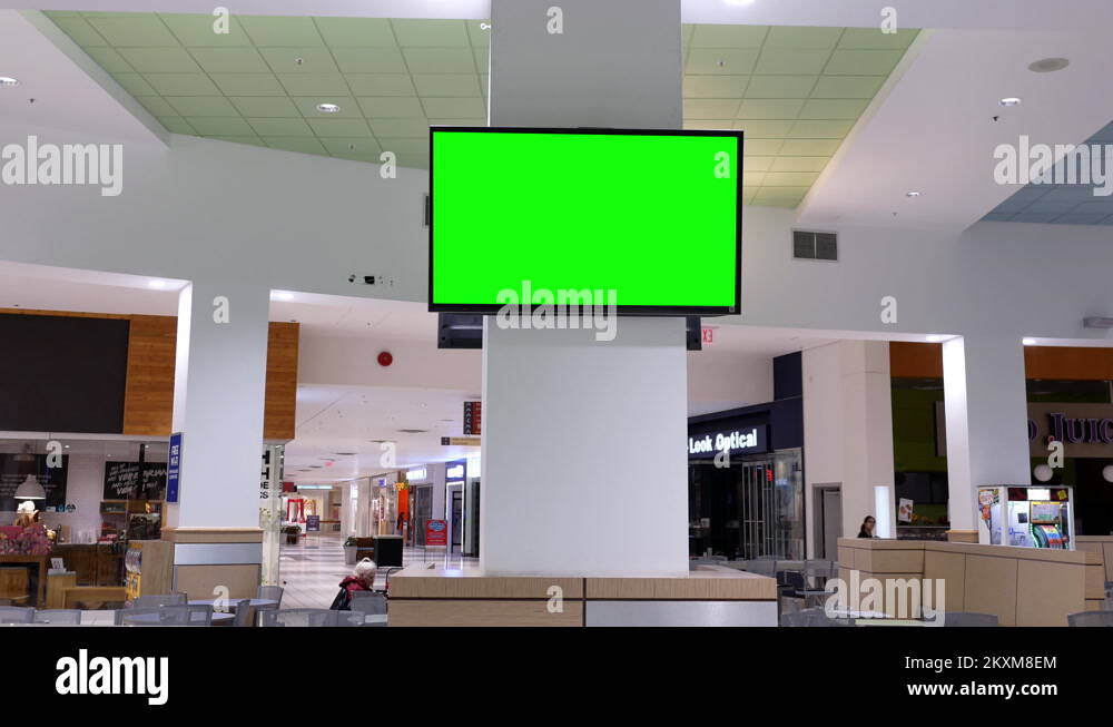 Modern TV with a green screen point of view inside food court area ...