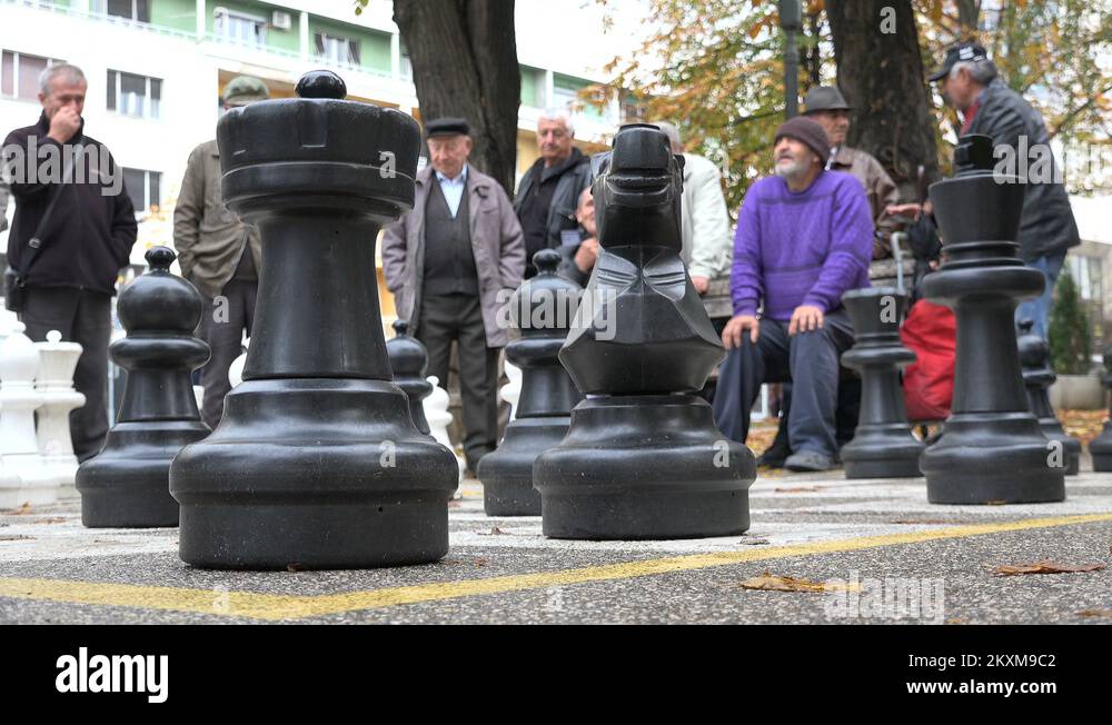 Audience of local senior men watch giant chess game in Banja Luka ...