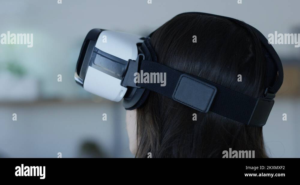 Young woman wearing VR 360 goggles - side profile - rack focus Stock ...