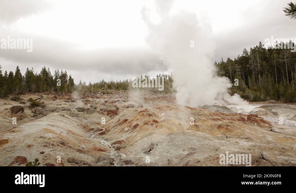 Steam and smoke rising from rocks in active volcanic area of ...