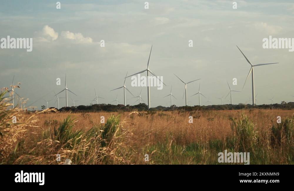 Small group of wind turbines spinning at small windmill farm in ...