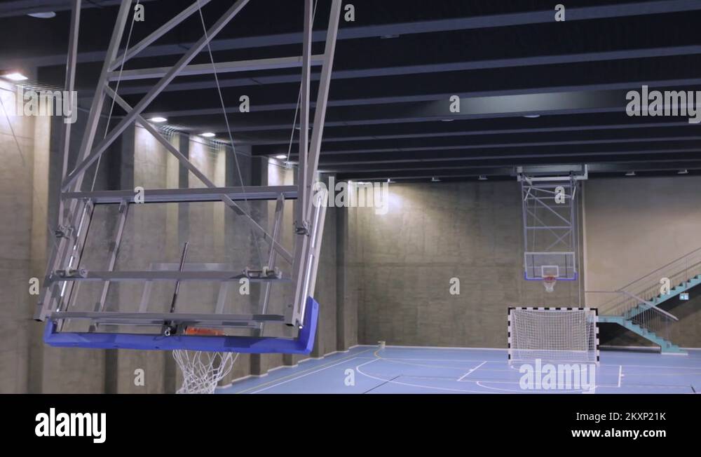 Empty sports and concerts hall. Ceiling mounted retractable basketball ...