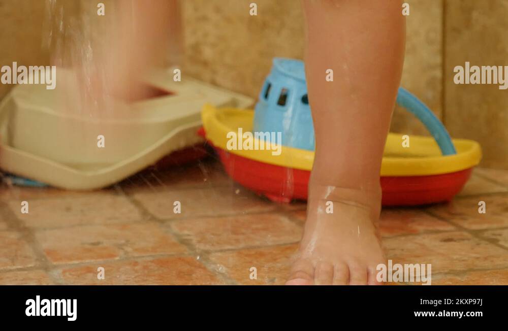Cute toddlers feet in a shower with toys Stock Video Footage - Alamy