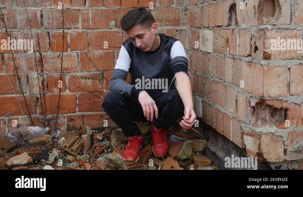 Male addict injects a syringe into a vein. Heroin or meth. Social ...