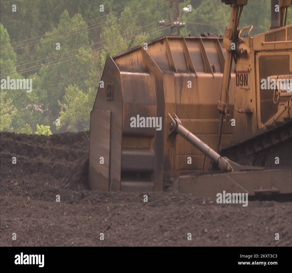 XCU bulldozer scoop as it moves coal forward; Continuous tracks of ...