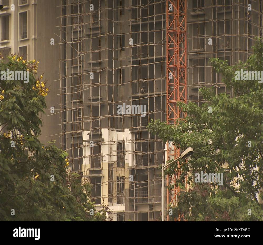 Tilt up, then down scaffolding and crane on high-rise under ...